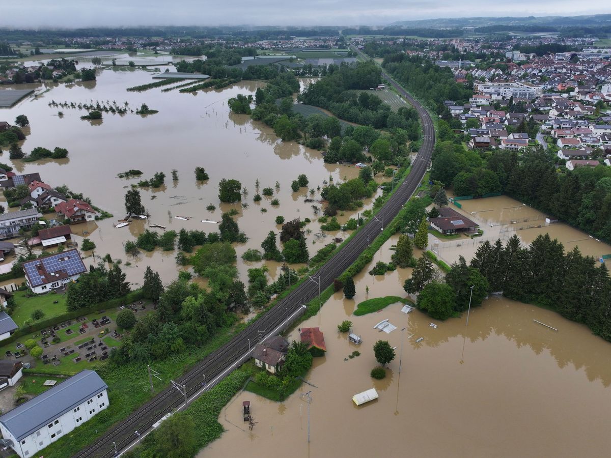 Firefighter dies and train derails amid heavy rain and flooding in ...