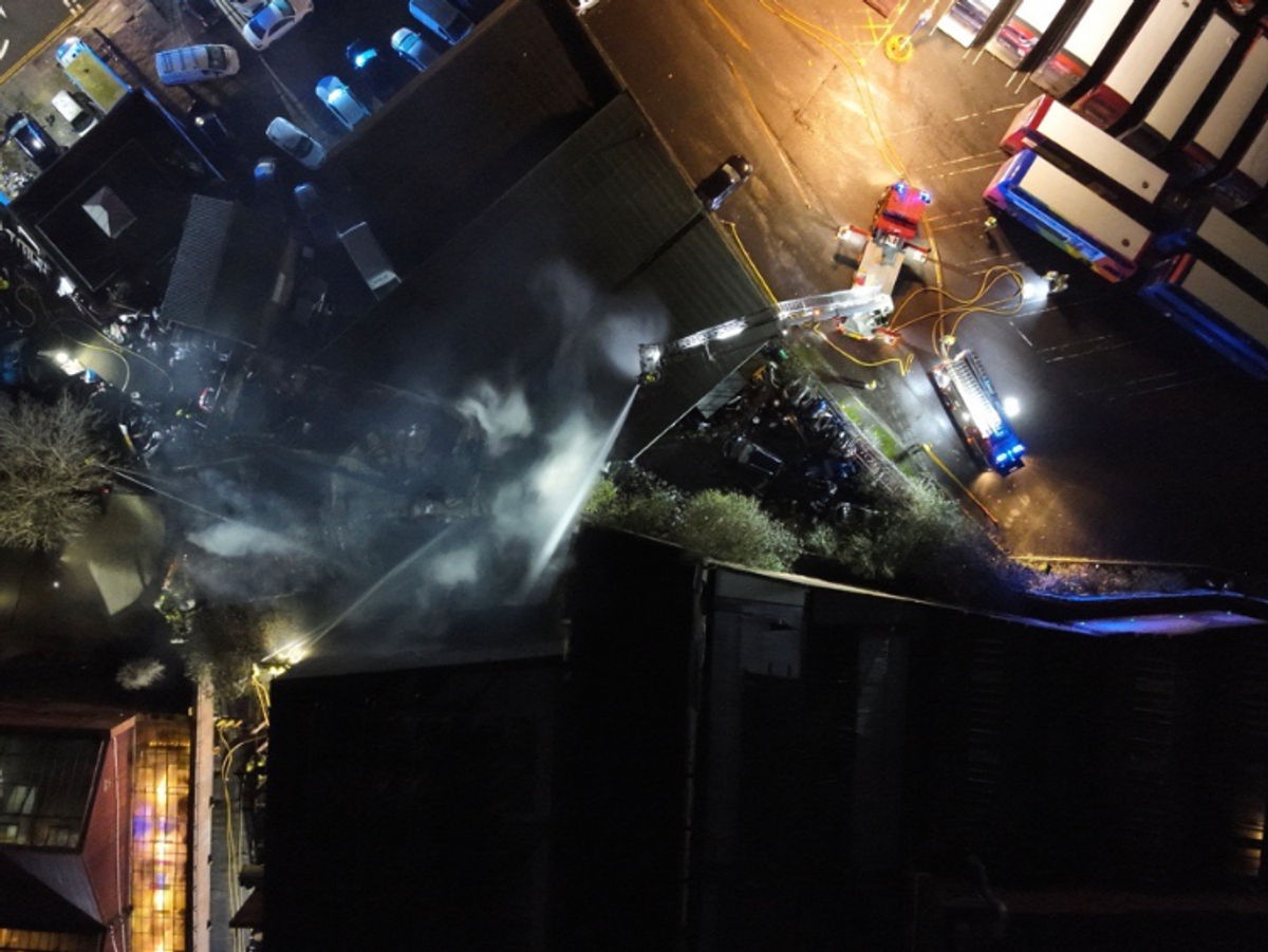 Dozens of firefighters tackle major blaze at Birmingham car workshop as neighbouring businesses ...