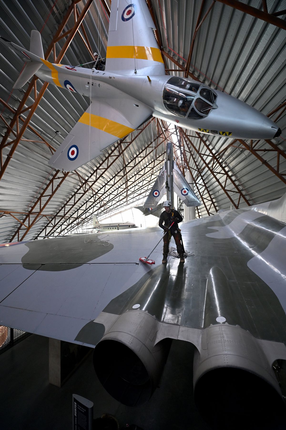 Flying high: Watch the RAF Cosford Museum team suspended 100ft in the air cleaning classic ...