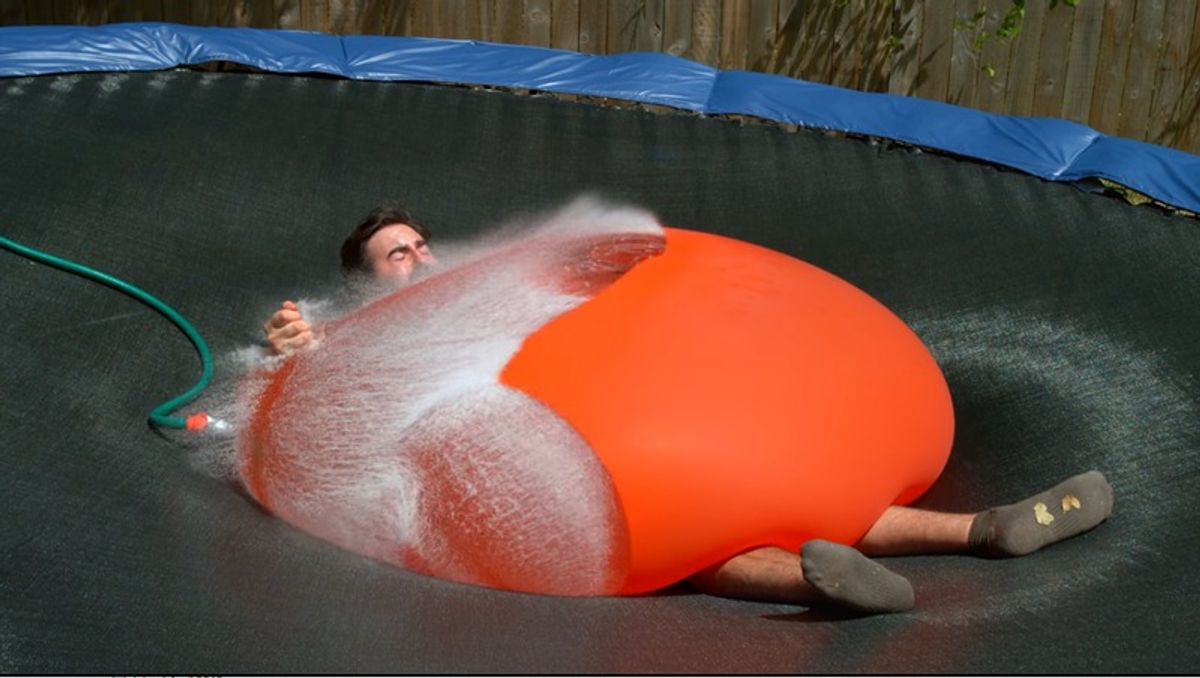 This giant water balloon bursting in slow motion is strangely ...