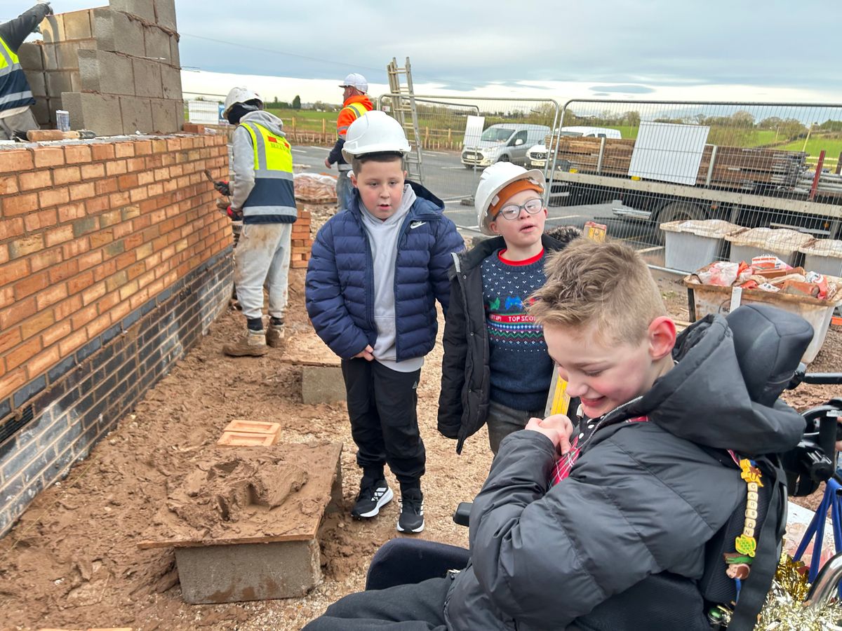 Children with disabilities help lay bricks of new permanent, inclusive ...