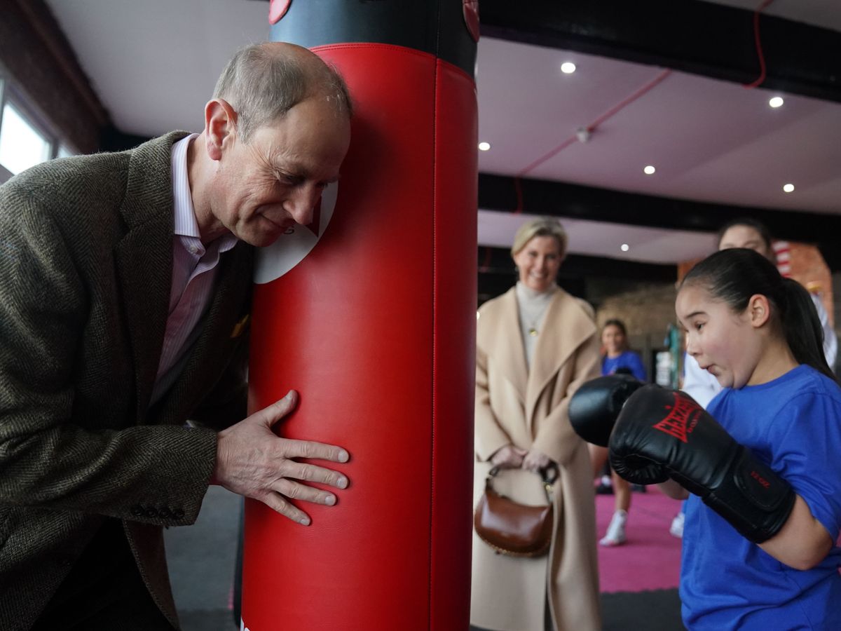 Duke of Edinburgh holds the punchbag in sparring session with young ...