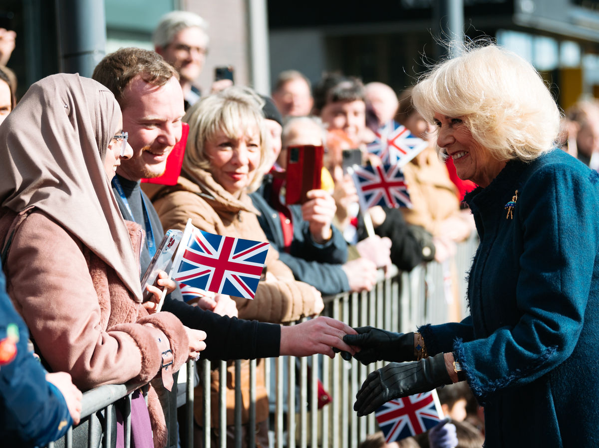 Flags wave and cheers go up as crowds welcome Queen Consort to Telford ...
